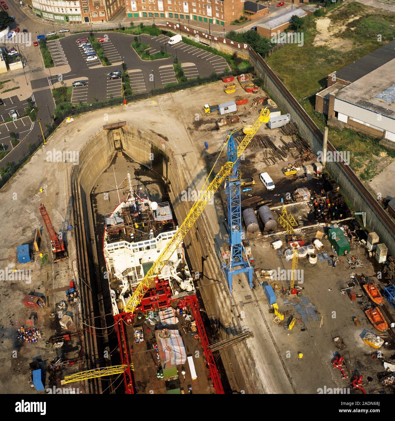Dry dock. Aerial photograph of a ship in a dock. Dry docks are where ...