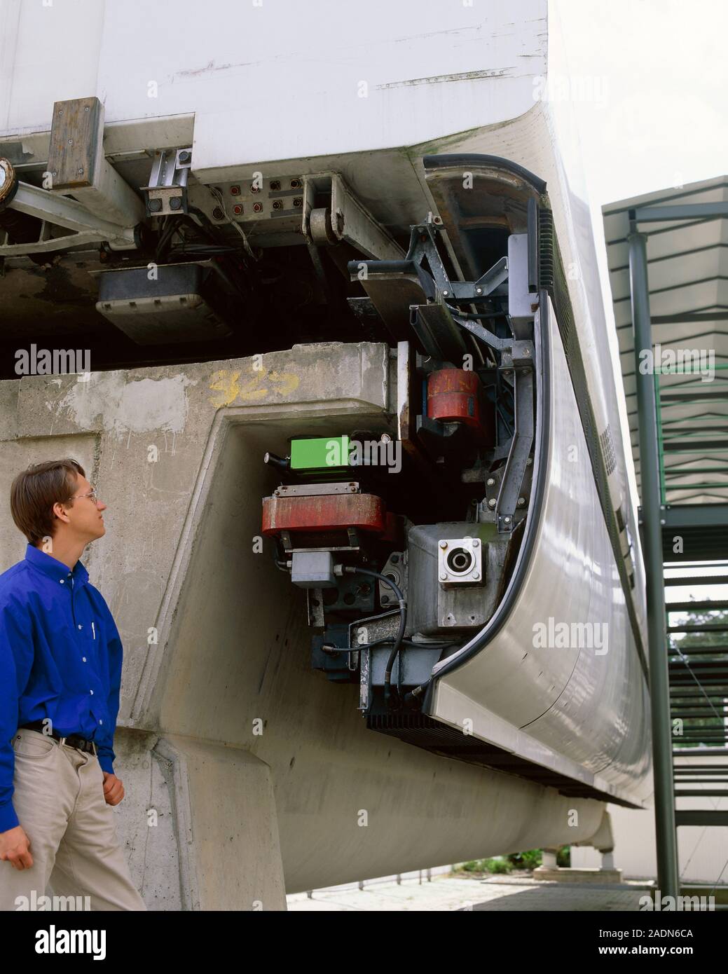 Maglev train & guideway. Man observing the end of a magnetic levitation ...