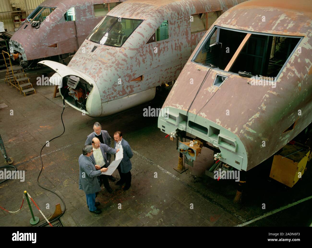 MODEL RELEASED. High-speed train assembly. Engineers discussing the ...