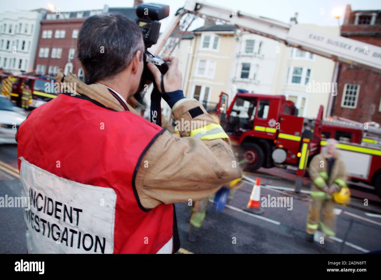 Incident investigator taking photographs of the scene of an incident ...