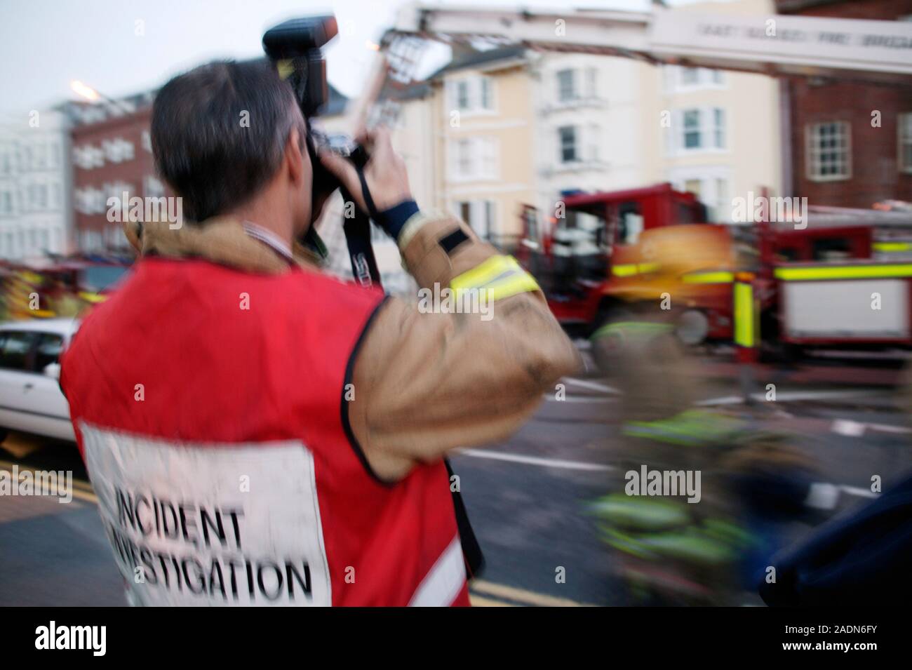 Incident investigator taking photographs of the scene of an incident ...