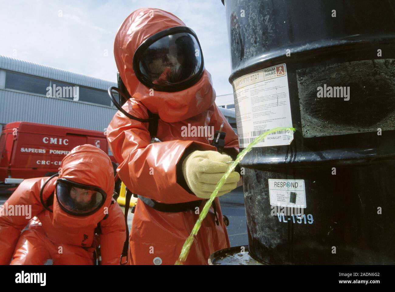 Contamination detection. Two firefighters analysing a contaminated ...