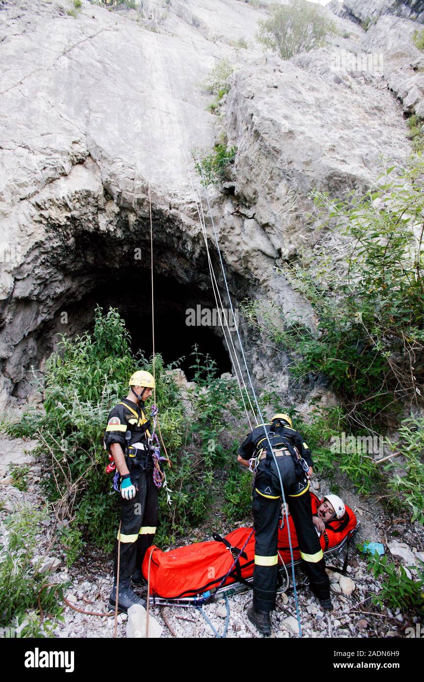 MODEL RELEASED. Mountain rescue workers stretchering a casualty up a ...