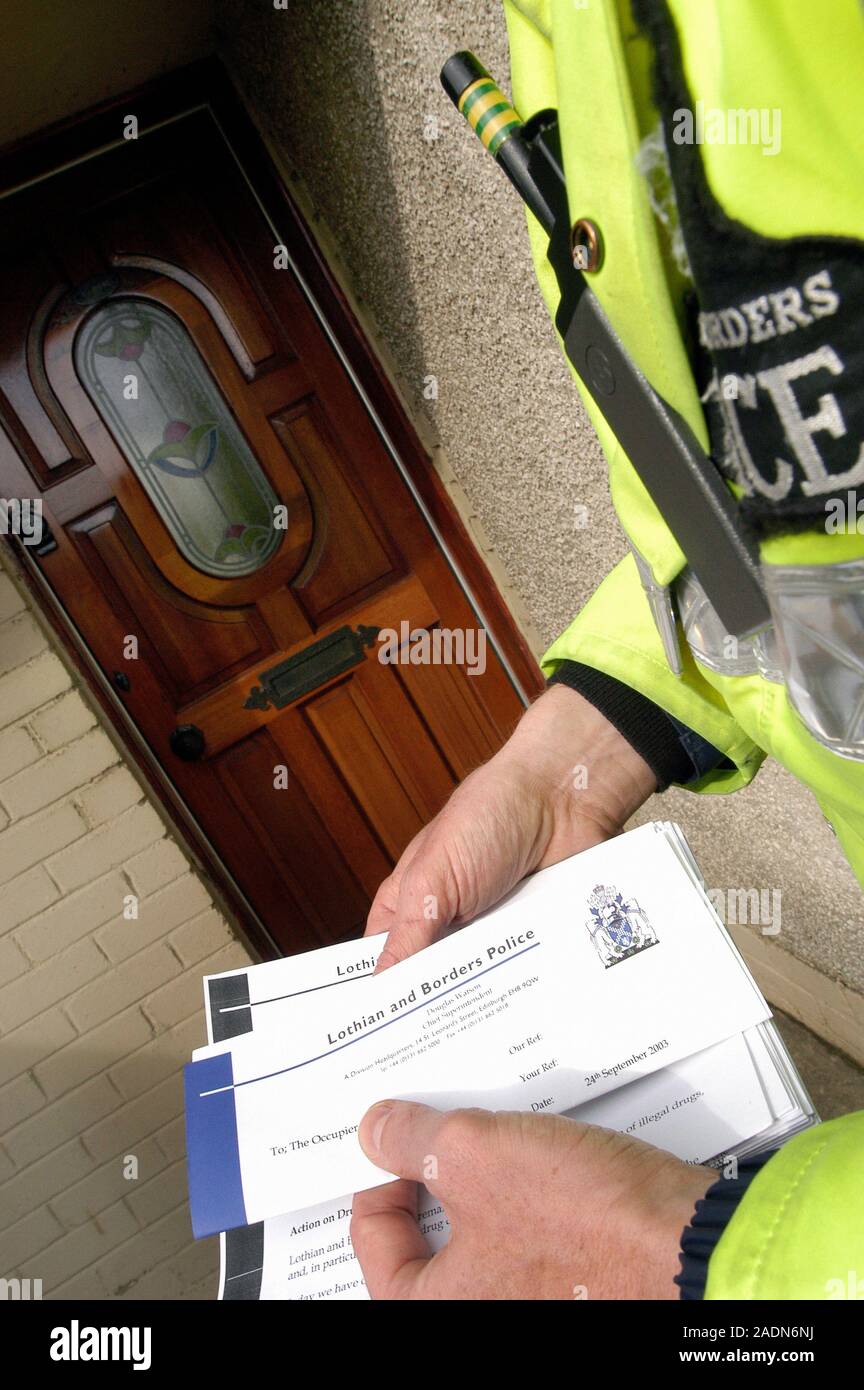 Crime prevention. Uniformed police officer distributing letters to ...