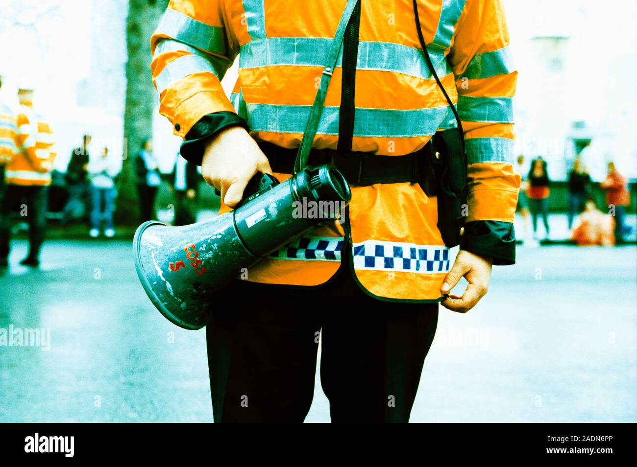 MODEL RELEASED. Police officer on duty holding an electronic megaphone ...