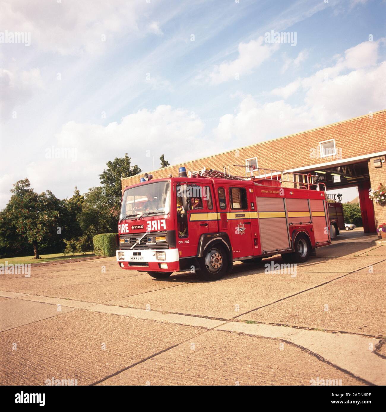 Fire engine at a fire station with its driver and crew inside ...