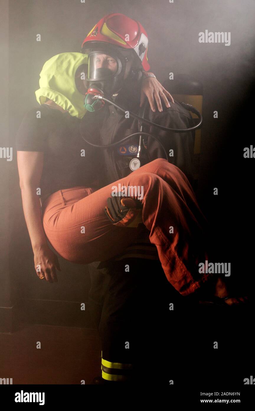 Firefighter training. Firefighter rescuing a smoke inhalation victim ...