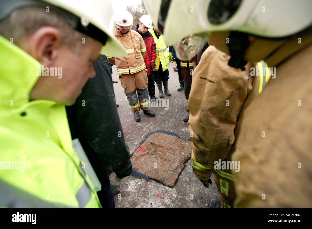 Firefighters examining evidence from a house fire. Evidence collected ...