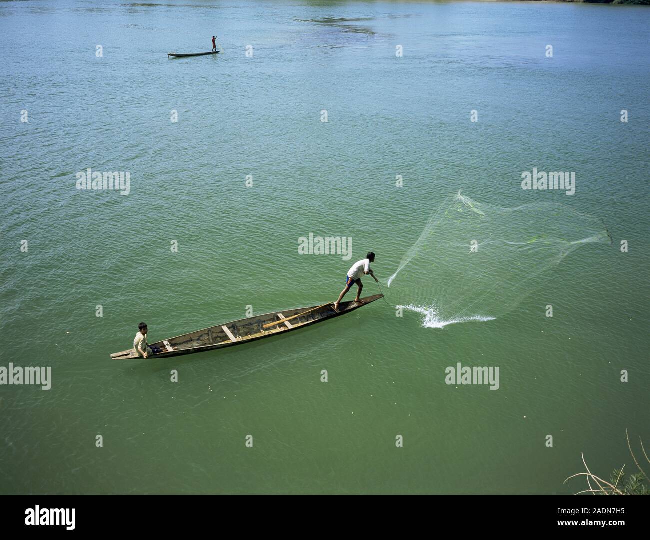 Men fishing in a boat. Photographed in Laos, southeast Asia Stock Photo ...