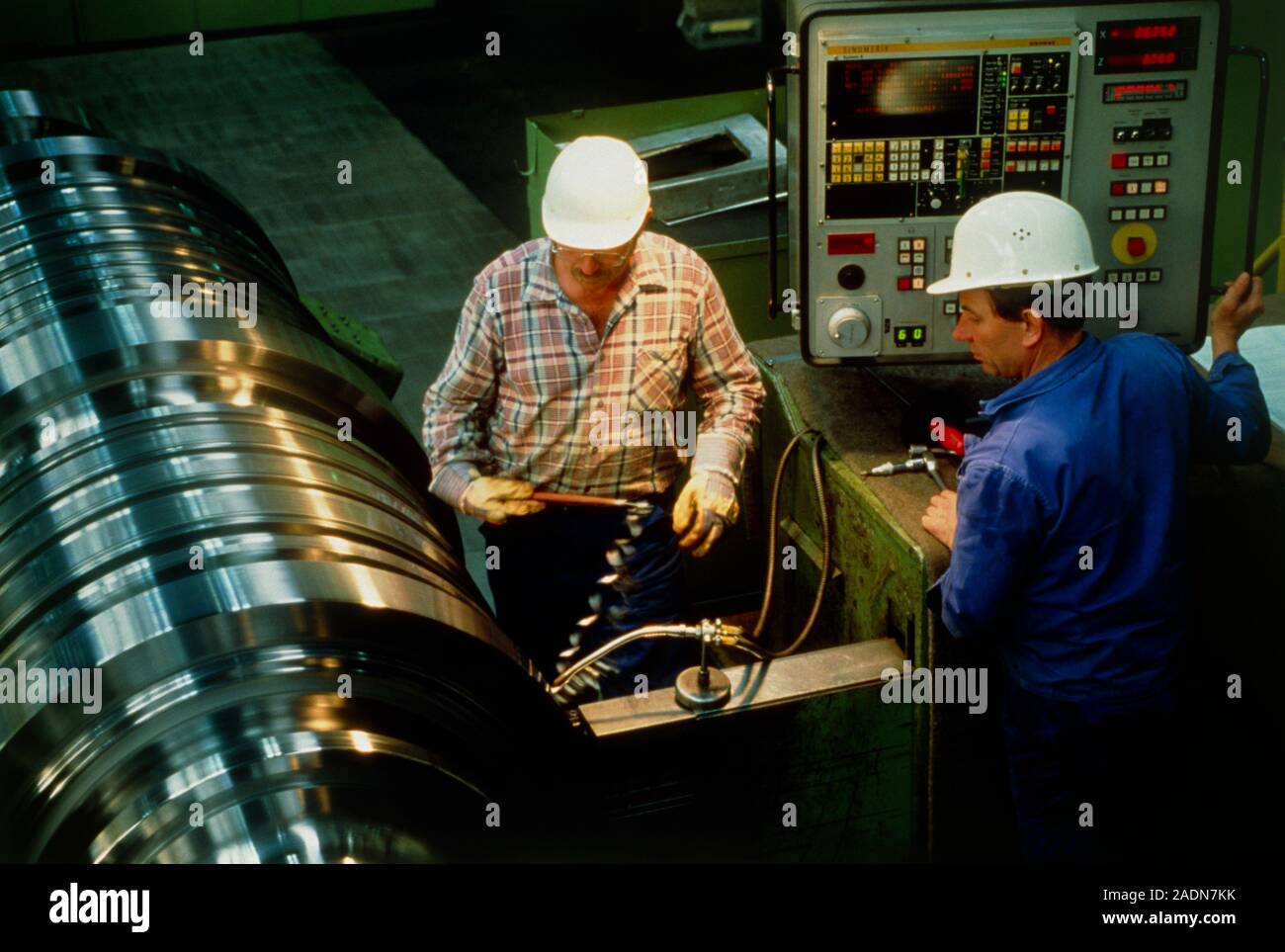 Turbine lathing. Engineers lathing a low-pressure turbine shaft ...
