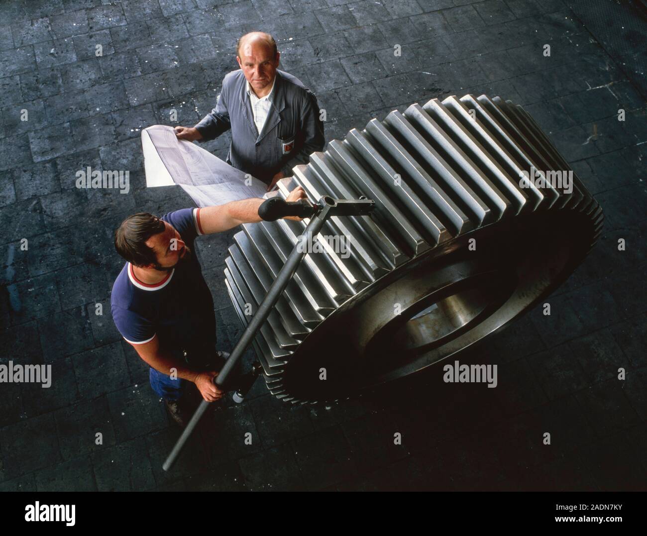 Component testing. Overhead view of engineers testing the surface ...