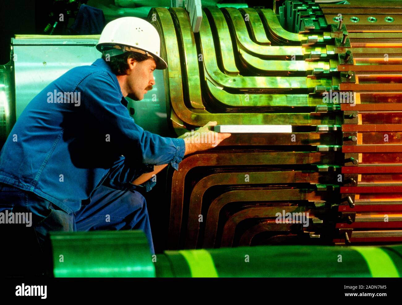 Electrical generator production. Engineer fitting electrical insulation ...