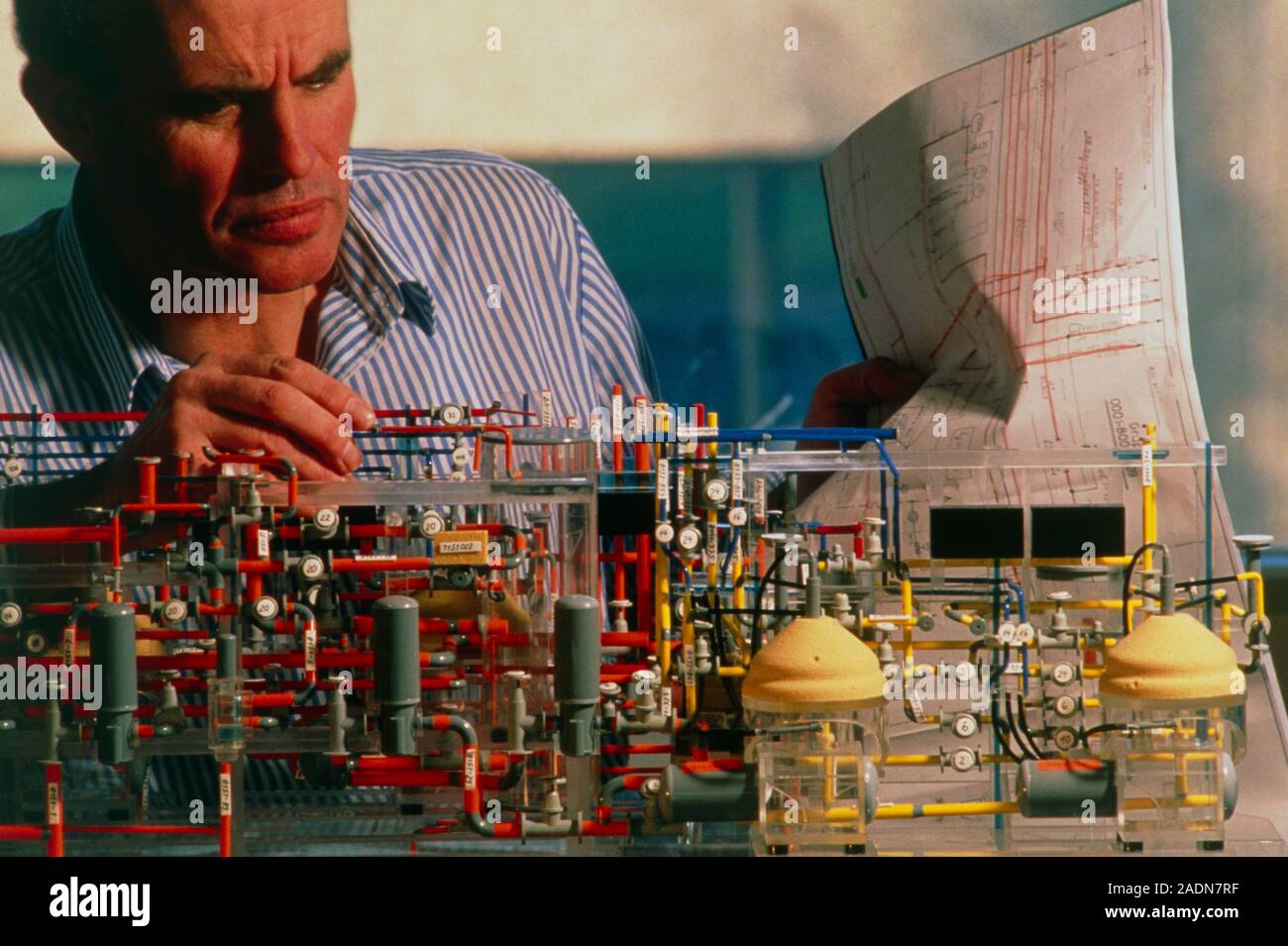Pipe system. Engineer constructing a three-dimensional scale model of a ...