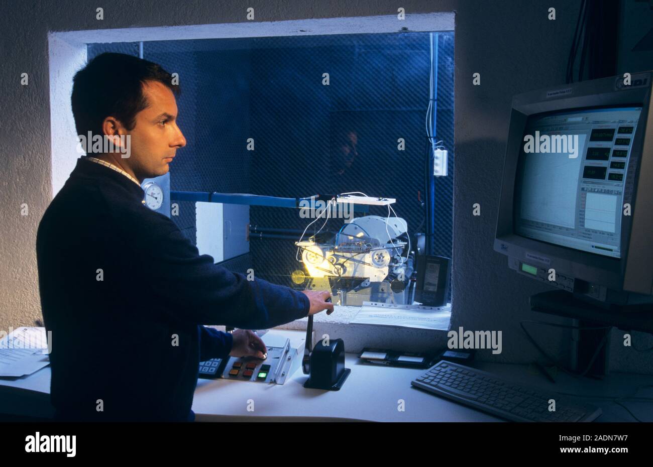 Compressed air car. Engineer conducting tests on the engine of the Air ...