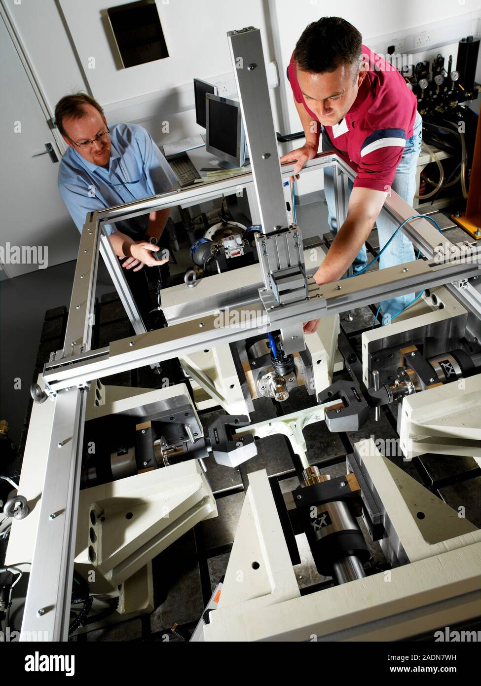 Mechanical strain testing. Physicists adjusting a multiaxial test ...