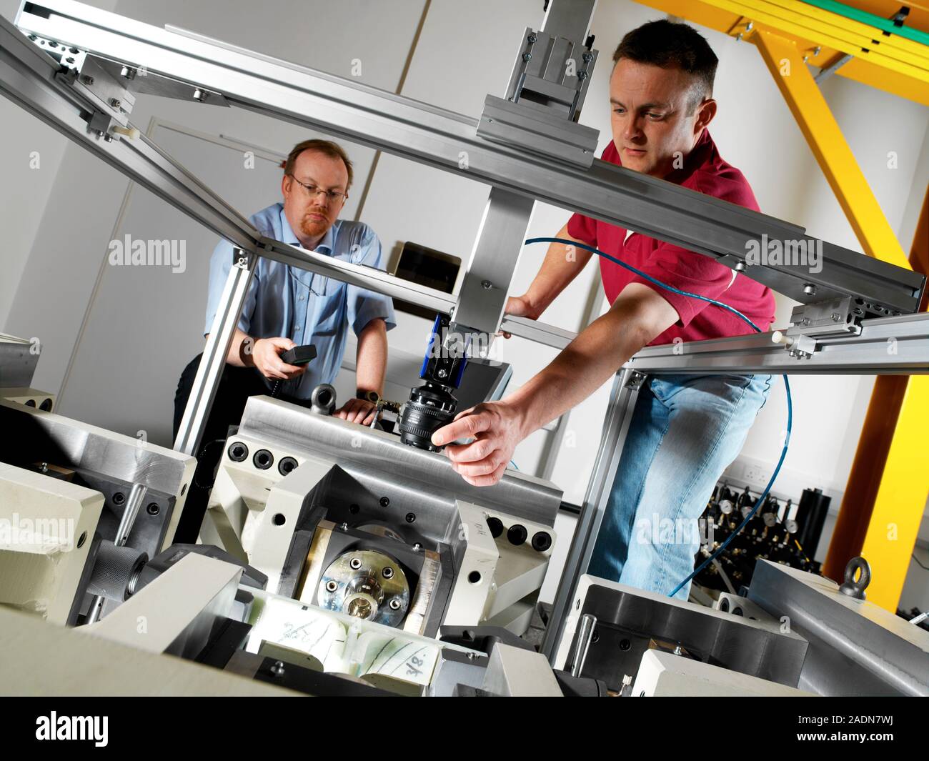 Mechanical strain testing. Physicists adjusting a multiaxial test ...