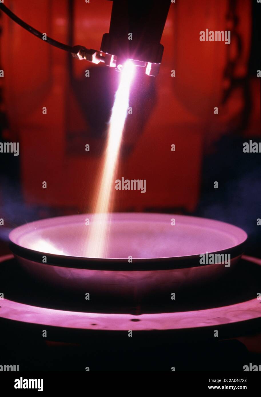 Plasma vapour deposition. Plasma torch coating the surface of a frying ...