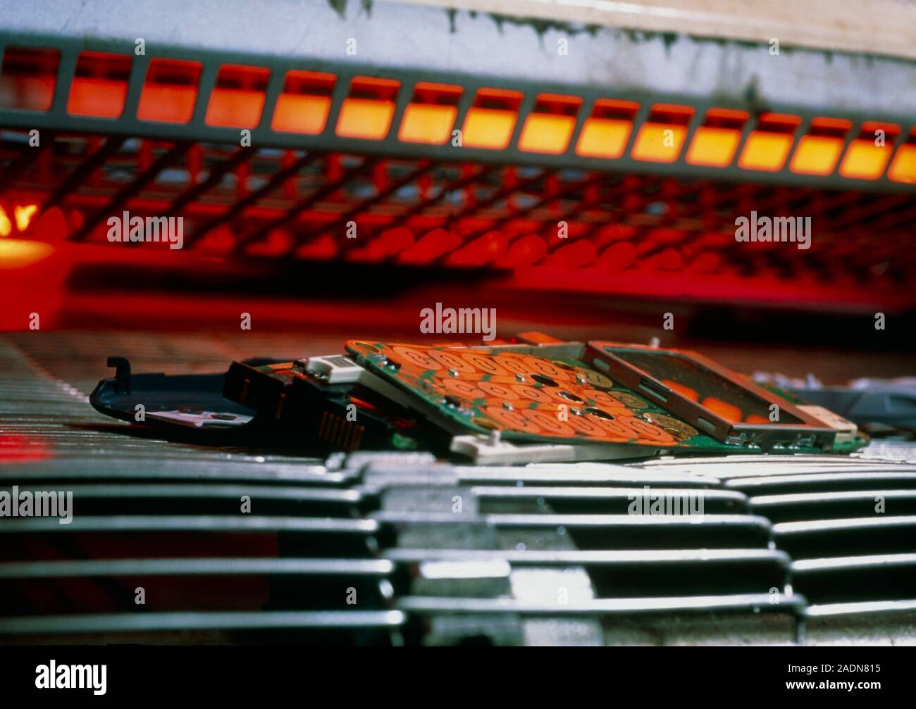Self-disassembling mobile phone components being heated on an infrared ...
