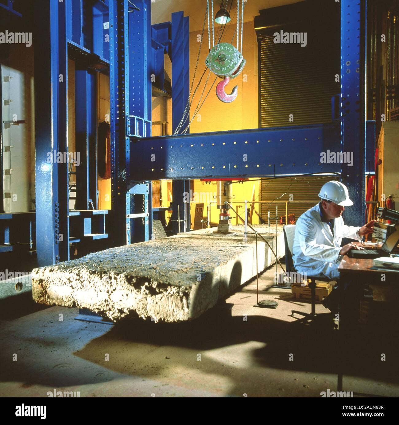 Bridge failure test. Engineer operating equipment to test the load ...