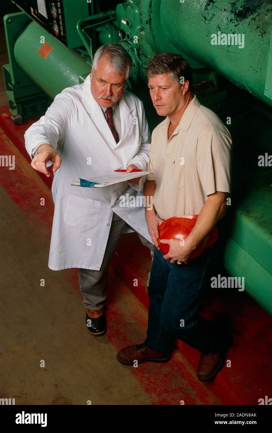 Health and safety at work. A medical doctor, on a visit to an ...
