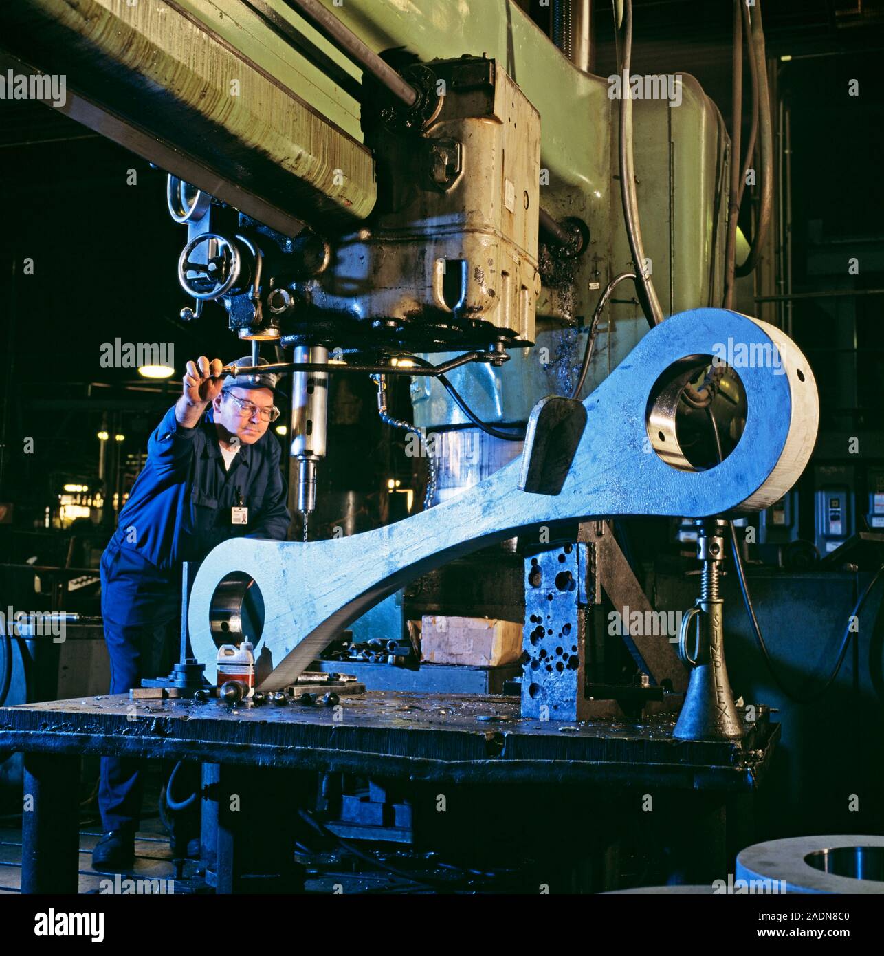 Wheel loader component. Worker with the component, known as the 'dog ...
