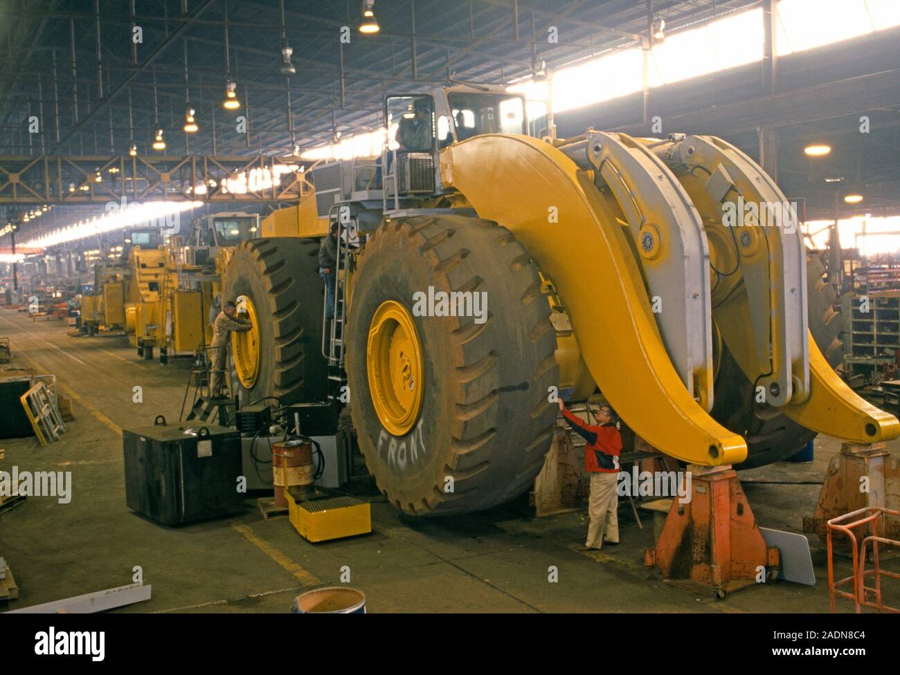 Wheel loader. Men working on a wheel loader production line. These are ...