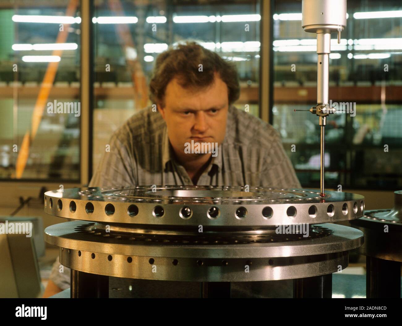 MODEL RELEASED. Machine part measurement. Engineer using a robotic arm ...