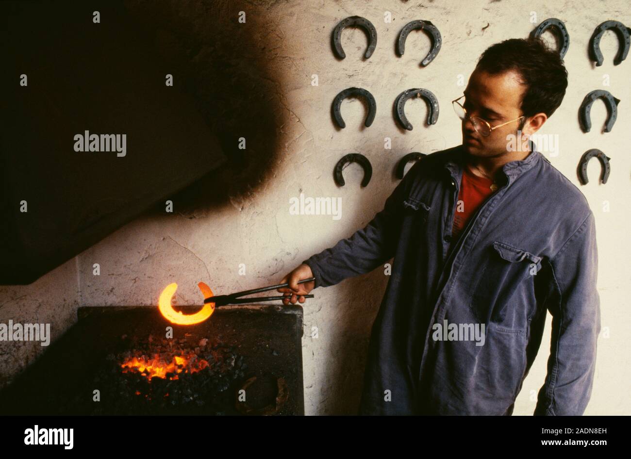 Blacksmith making a horseshoe Stock Photo - Alamy