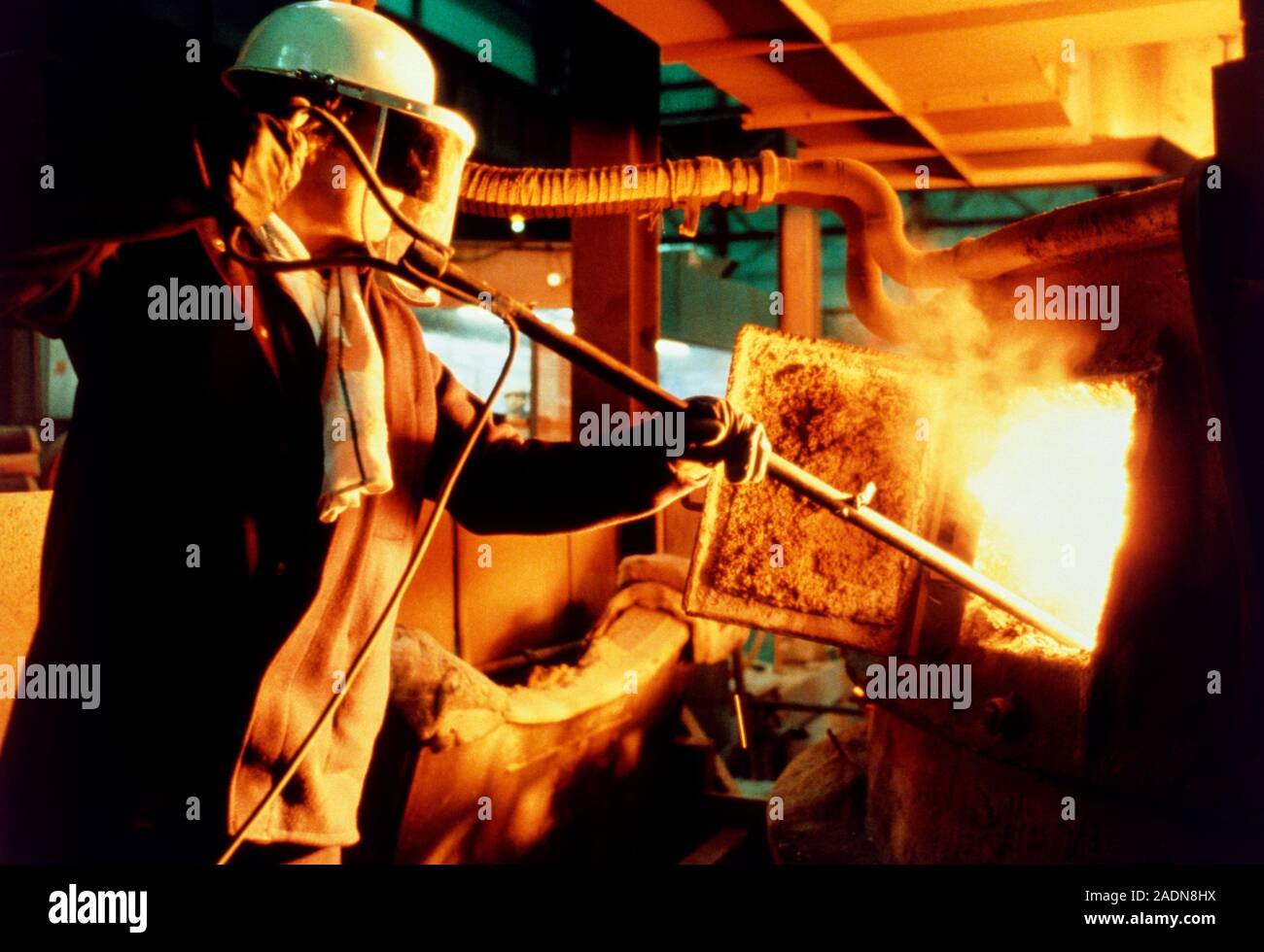 Steel production: an electric arc furnace being charged with molten ...
