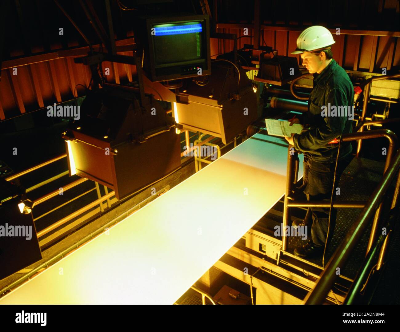 Quality control. Worker conducting a visual inspection of hot ...