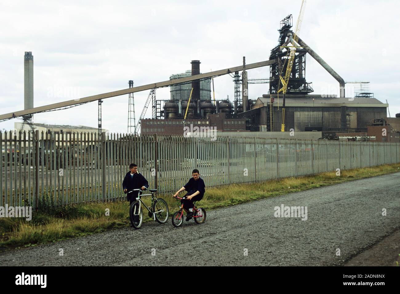Steel works. Two boys on bikes next to the Corus steel works ...