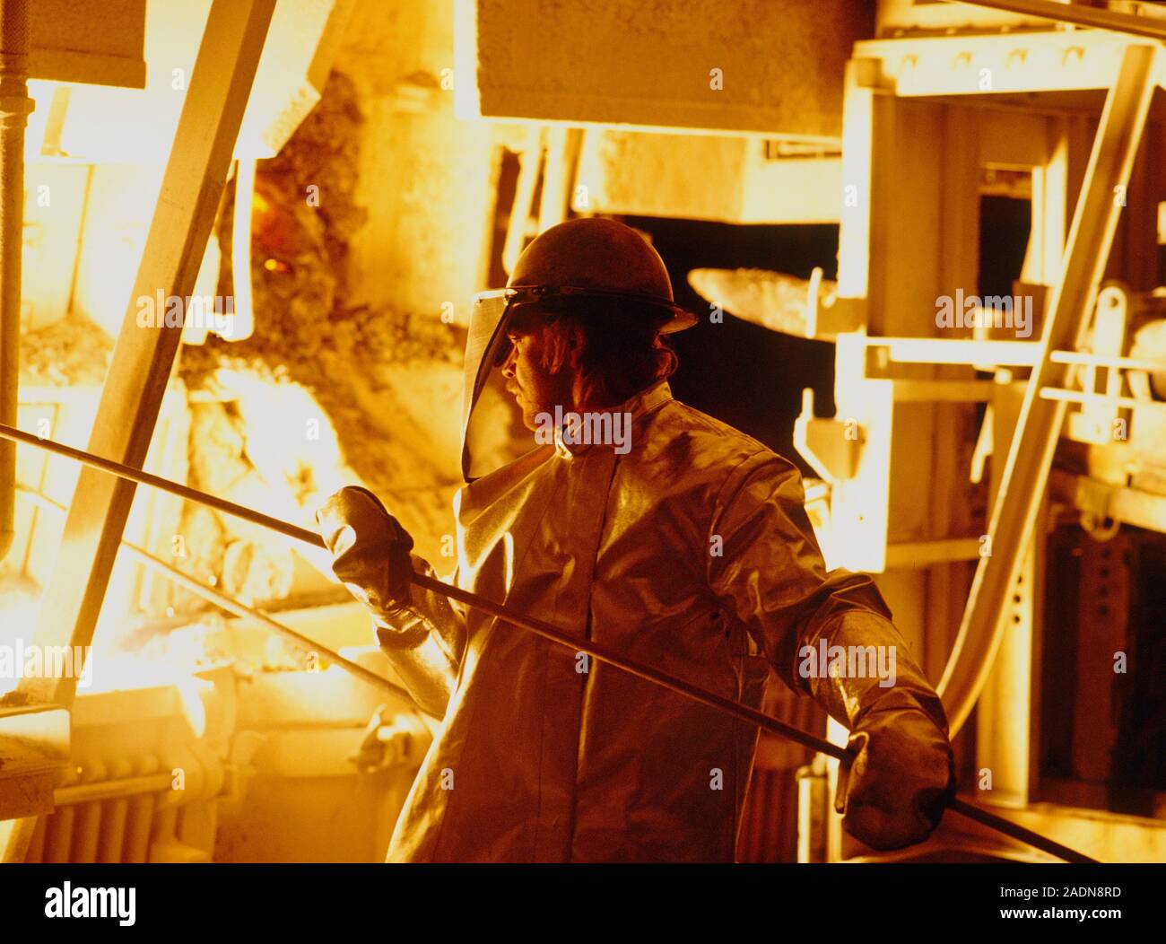 MODEL RELEASED. Steel production. Worker at a steelworks standing in ...
