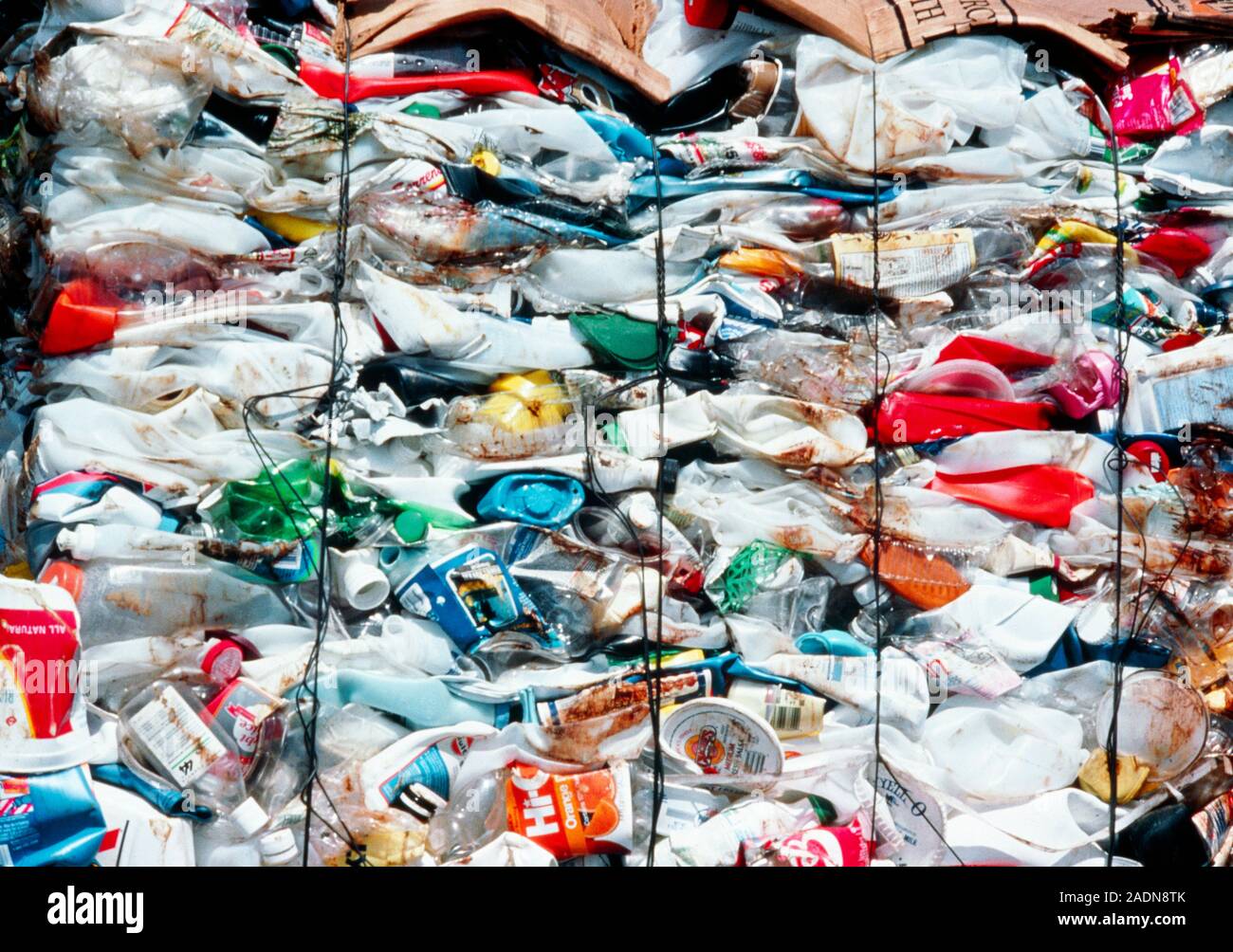 Plastic recycling. Bale of compressed plastic items of HDPE (High ...