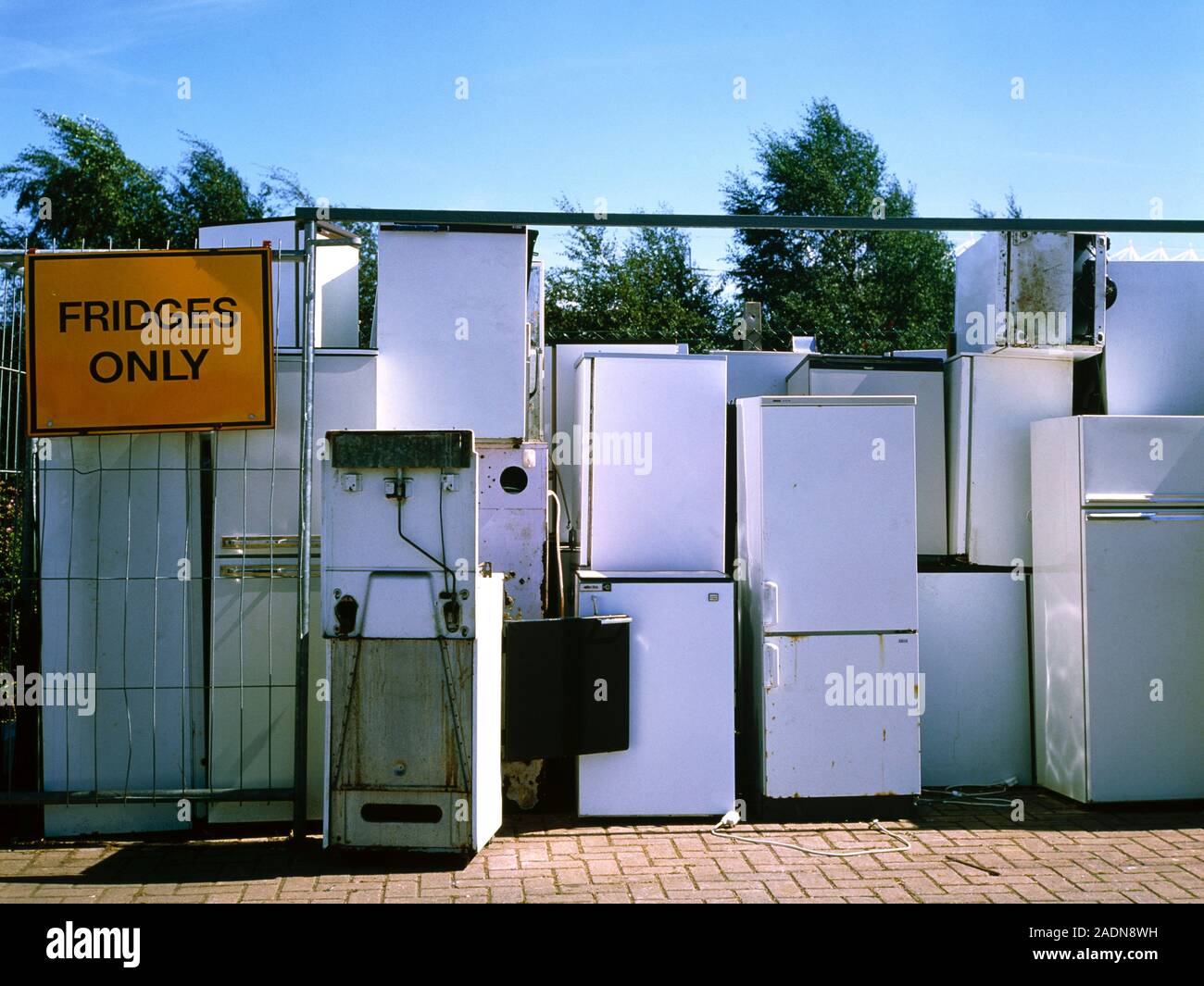 Refrigerator recycling. Refrigerators stacked ready for recycling at a ...