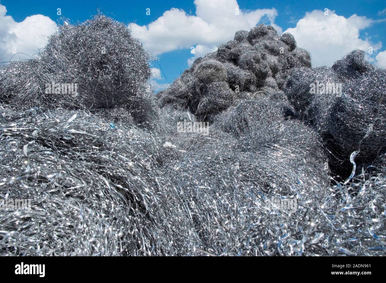Recycling waste metal. Shredded metal ribbons produced during the ...