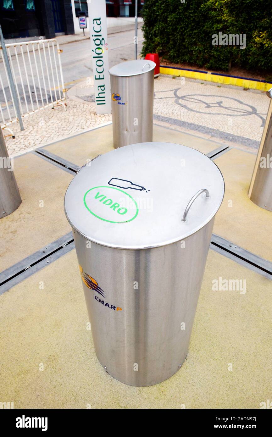 Bottle bank. Recycling bins for glass bottles at a recycling centre ...
