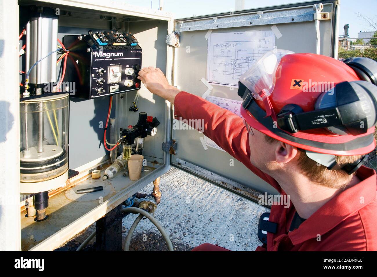 MODEL RELEASED. Automatic waste water sampling. Engineer adjusts the ...