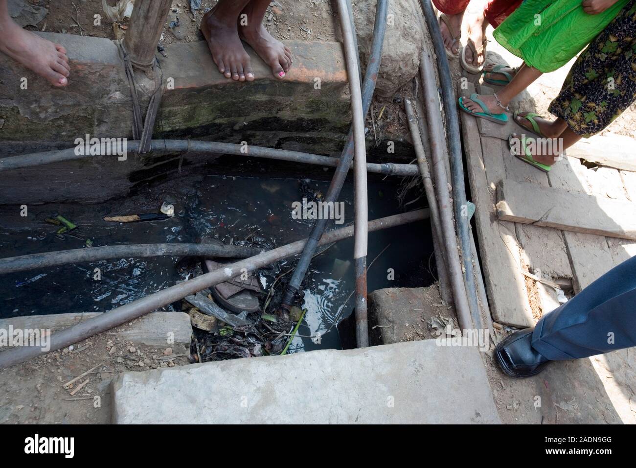 MODEL RELEASED. Open sewer. Photographed at a slum, in Dhaka ...