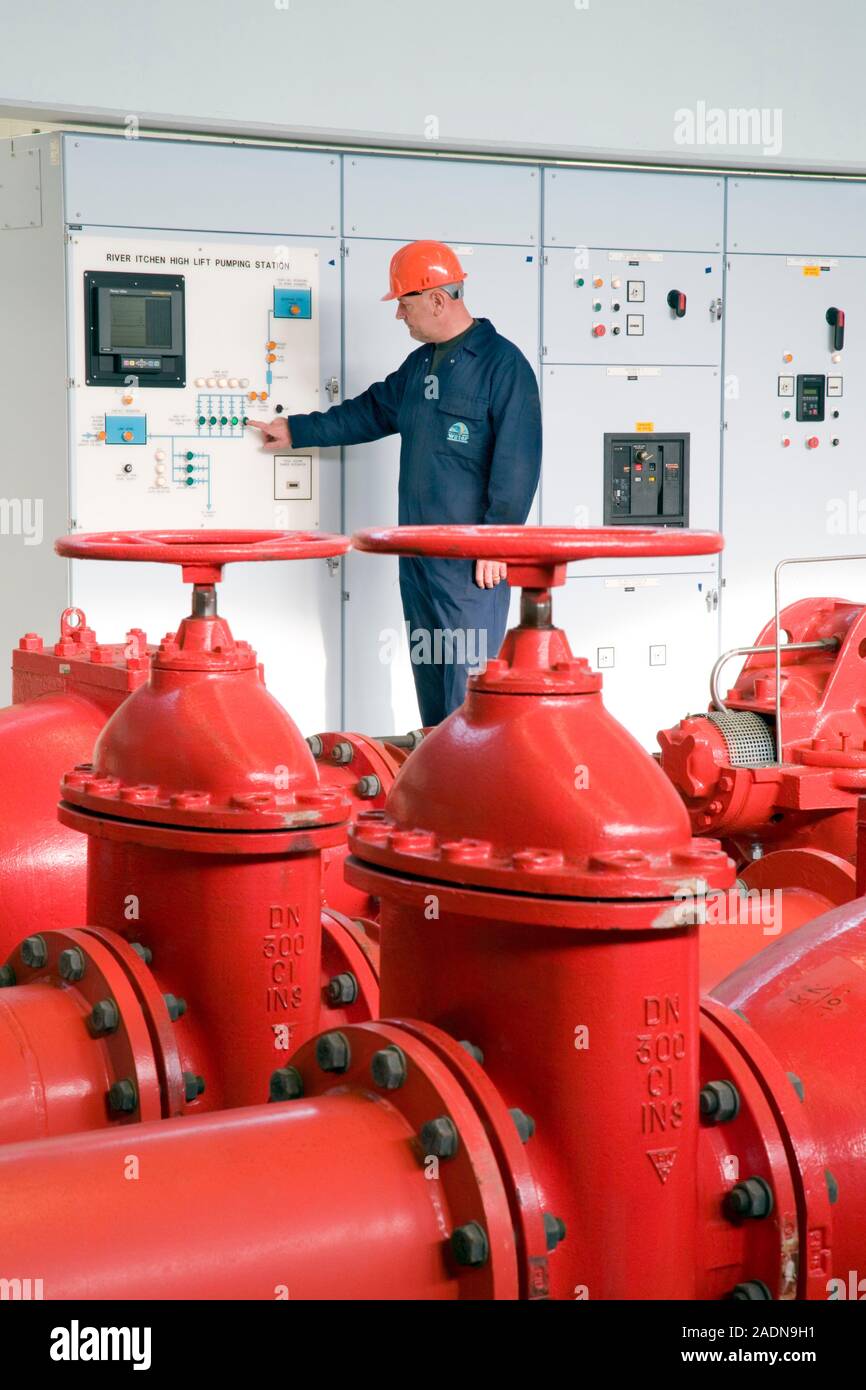 MODEL RELEASED. Pumping station. Operator adjusting controls in a high ...