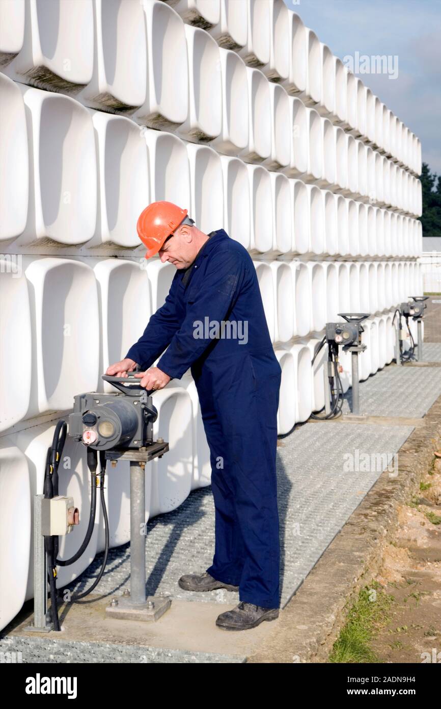MODEL RELEASED. Water treatment. Operator opening an external valve on ...
