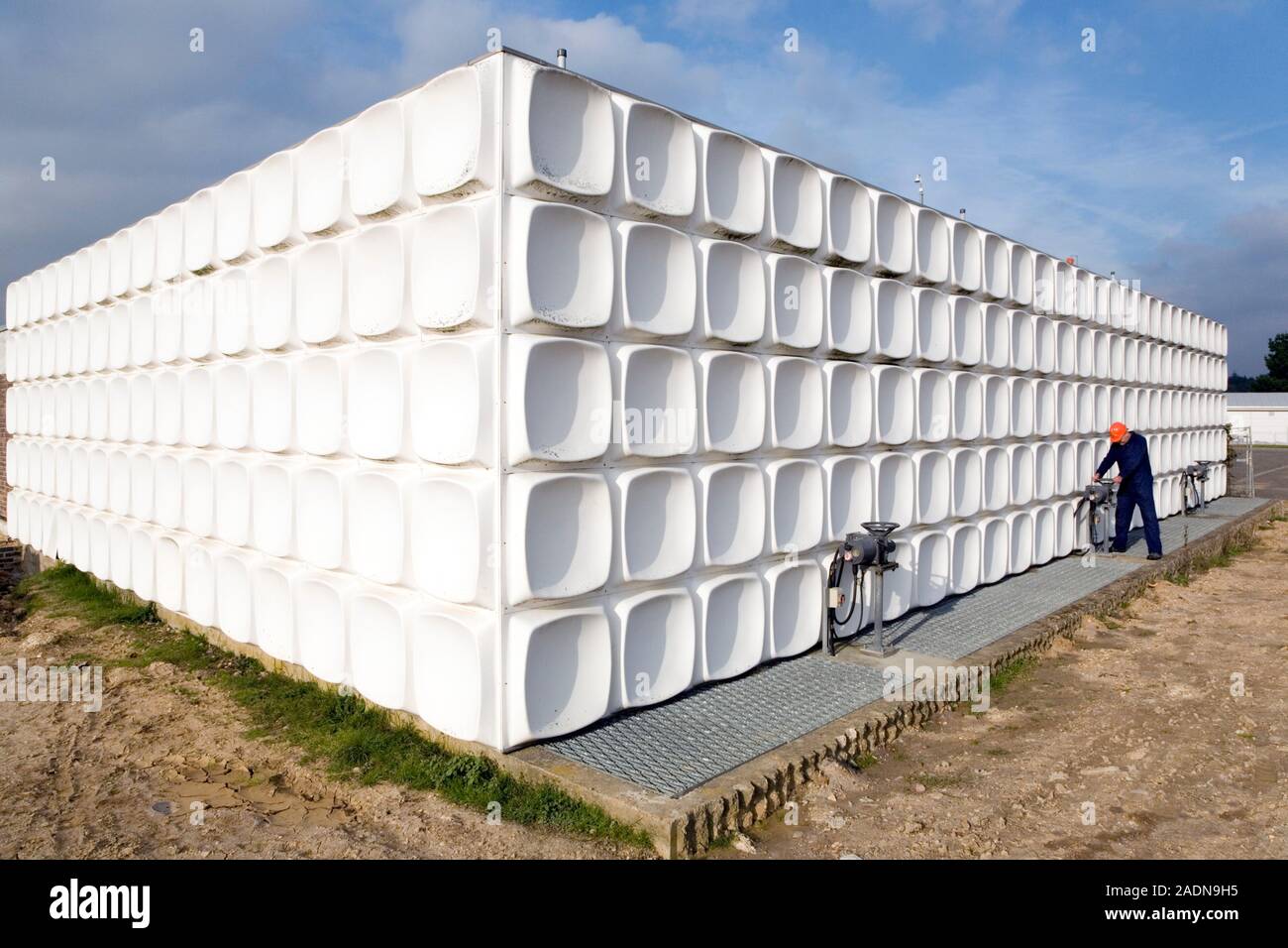 MODEL RELEASED. Water treatment. Operator opening an external valve on ...