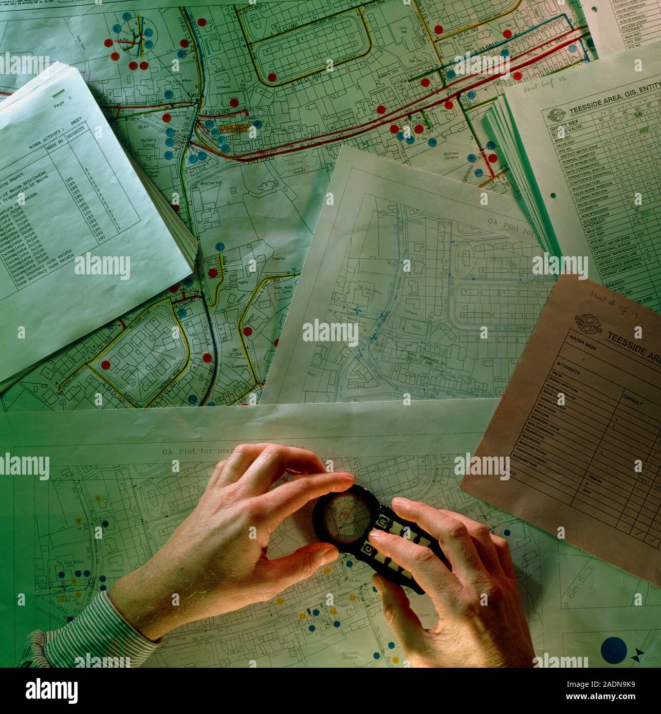 Water mains mapping. Hands using a device to send the coordinates of ...