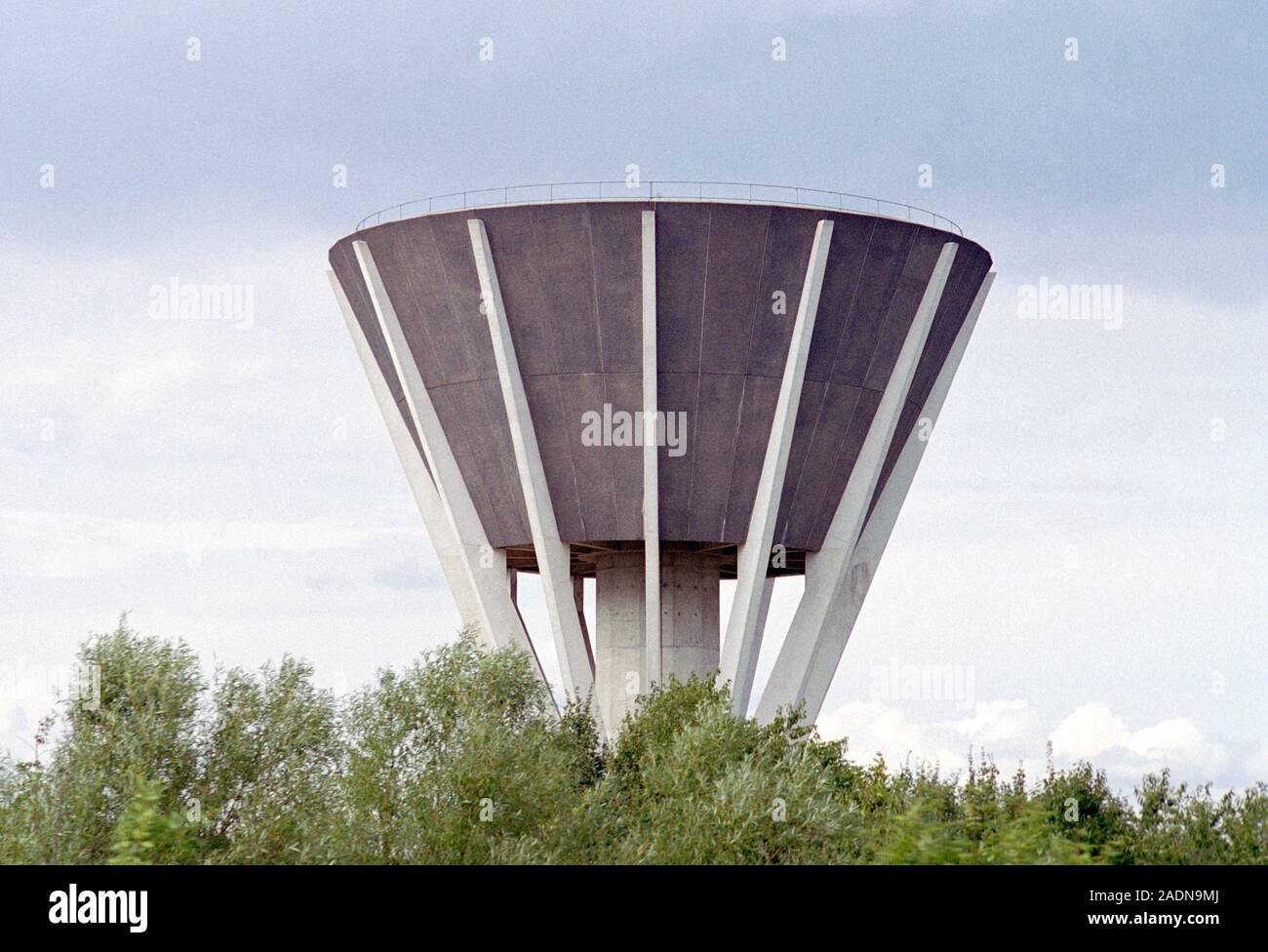 Water tower amongst trees. The water tower is tall to maintain water ...