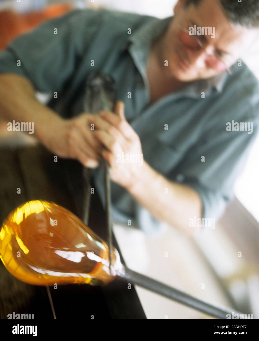 Glass blower shaping a parison (molten glass Stock Photo - Alamy