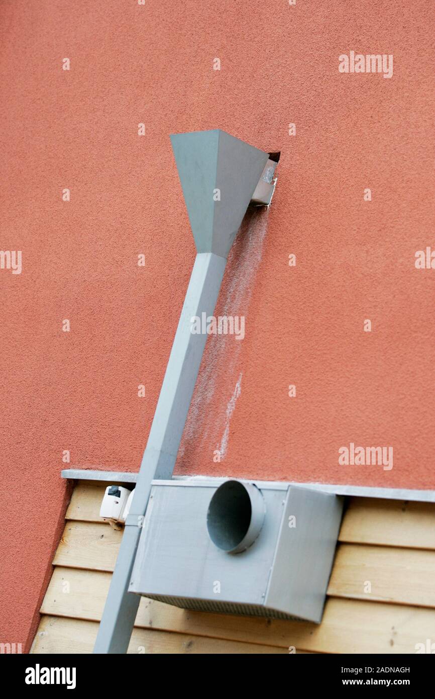 Guttering (top) and ventilation inlet (bottom) on the exterior of a eco ...