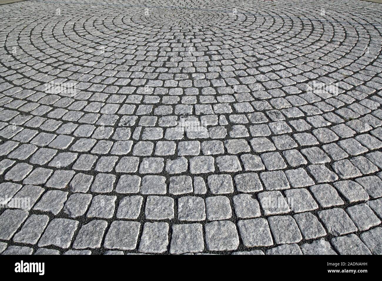 Granite paving laid in a circular pattern. Photographed in Dusseldorf ...