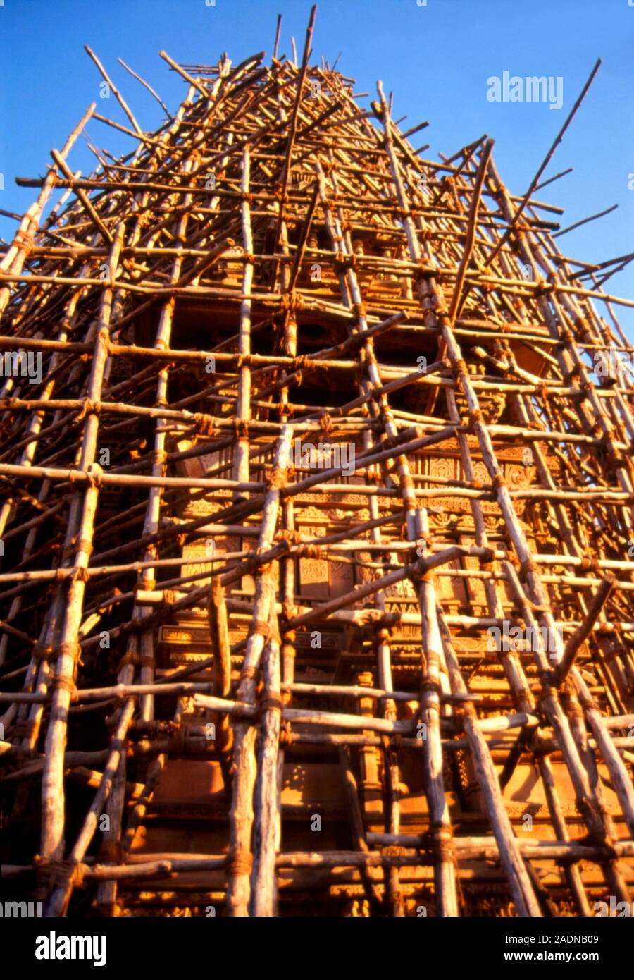 Wooden scaffolding. Scaffolding made out of wood poles tied together ...