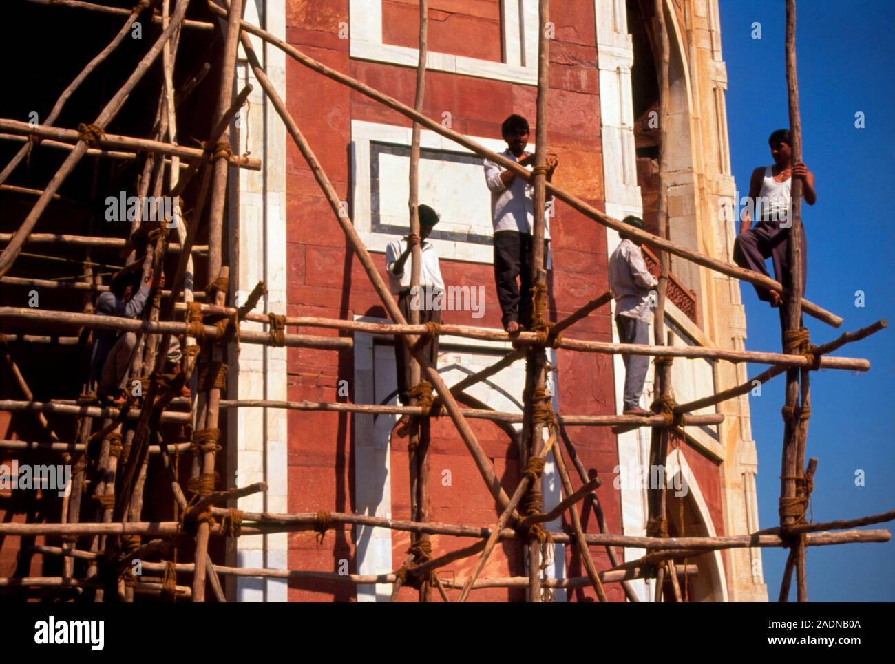 Wooden scaffolding. Scaffolding made out of wood poles tied together ...