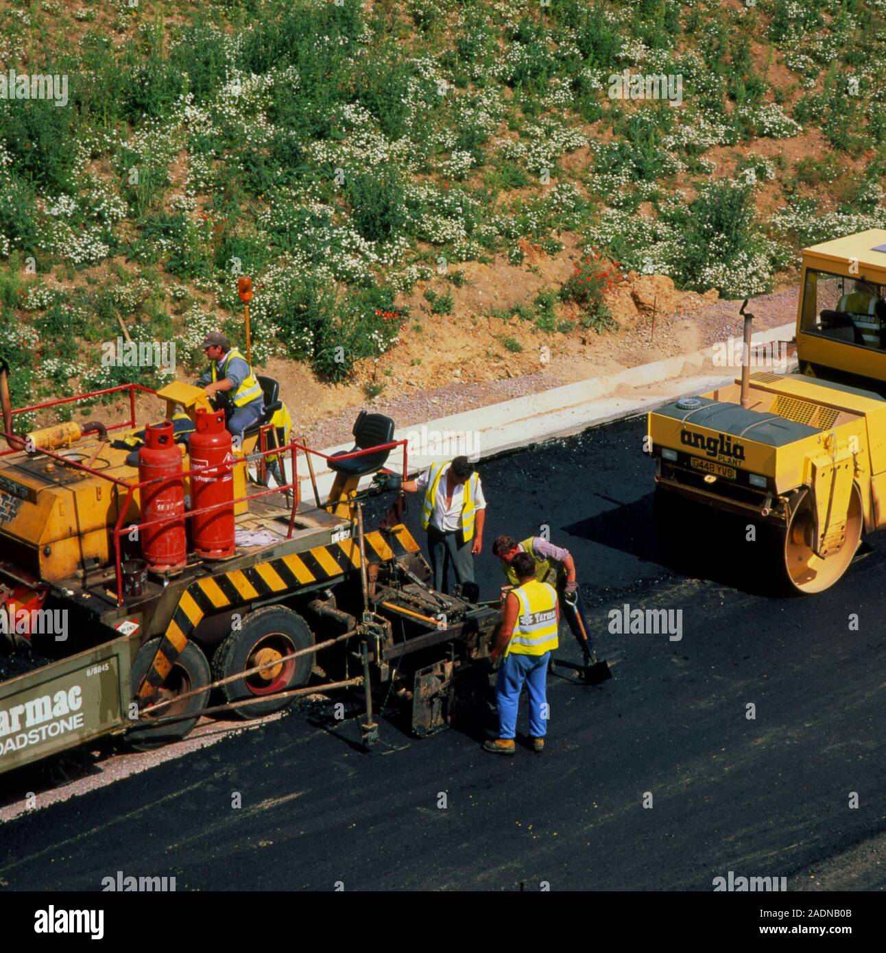 Road construction. Laying of the second course of a road. Asphalt ...