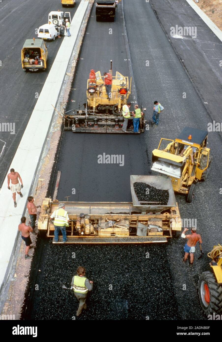 Road construction. Laying of the top 'wearing' course of a road. A ...